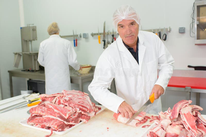 Butcher cutting up meat stock image. Image of looking - 118384491