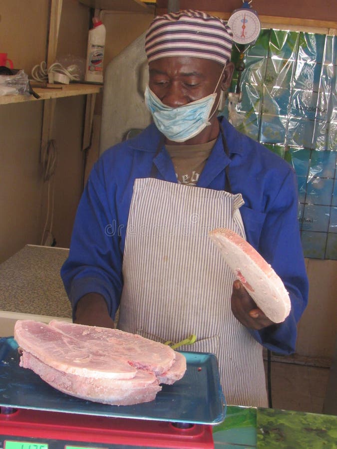 Butcher with Face Mask Weighing Meat on Scale Editorial Photography ...