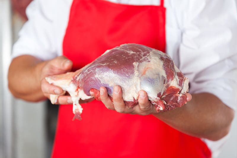 Butcher Holding Meat in Store Stock Photo - Image of prepare, fresh ...