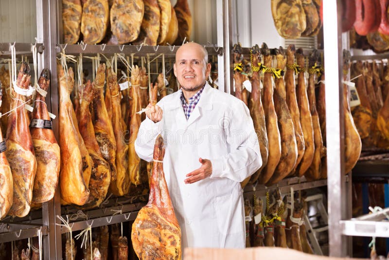 Butcher with jamon joints stock photo. Image of cured - 66734120