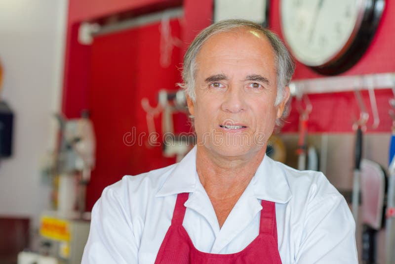 Butcher looking at camera stock photo. Image of shop - 214070630