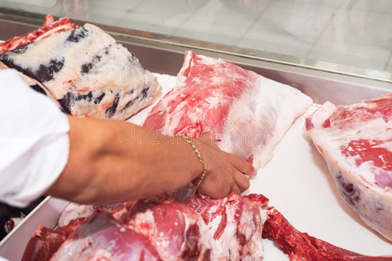 Butcher Offering Fresh Meat at Display in Butchery Stock Image - Image ...
