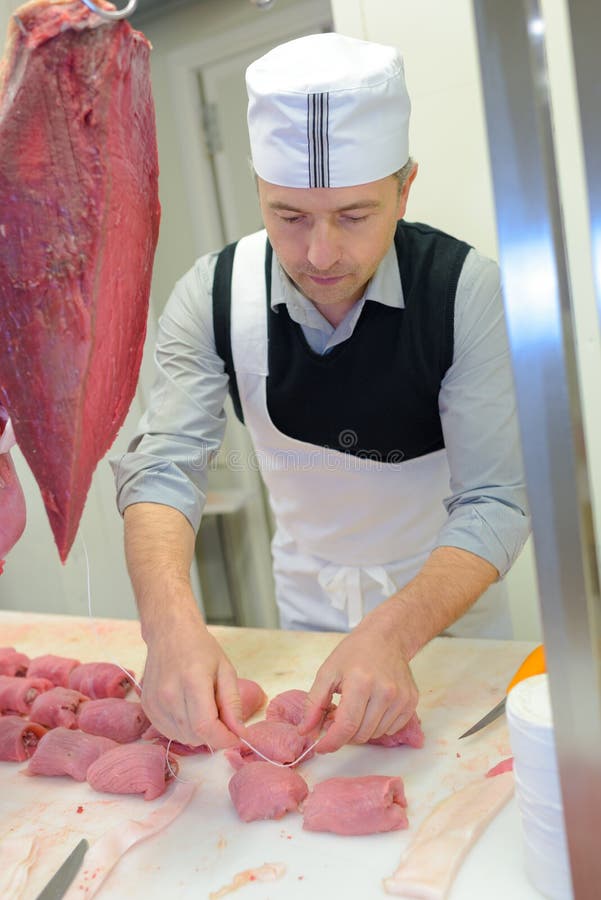 Butcher preparing meat stock photo. Image of processing - 203372574