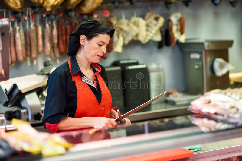 Butcher Sharpening a Knife in a Butcher Shop Stock Photo - Image of ...
