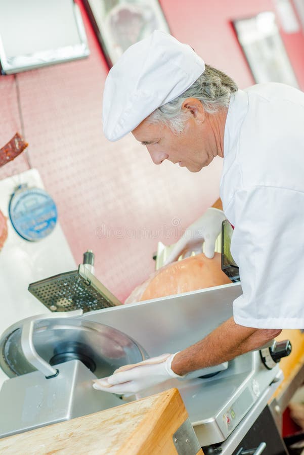Butcher slicing ham stock image. Image of slicer, butcher - 161829037