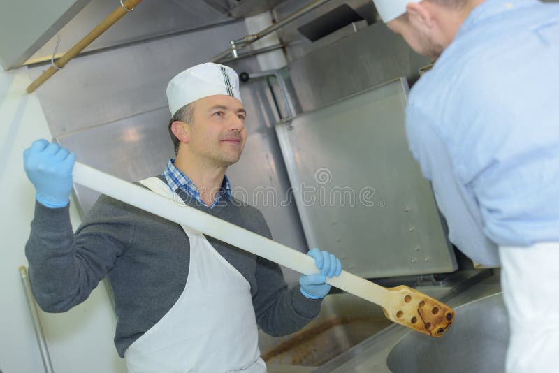 Butcher Teaching Apprentice How To Prepare Meat Stock Photo - Image of ...