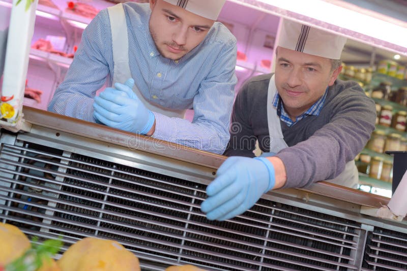 Butcher Teaching Young One How To Sell Meat Stock Photo - Image of ...