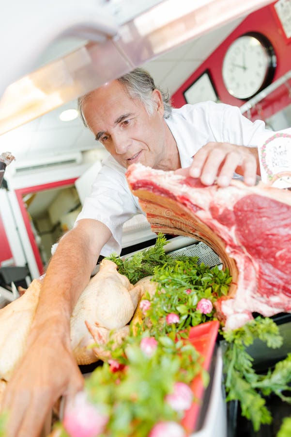 Butcher at work stock photo. Image of lamb, shop, customer - 247687258