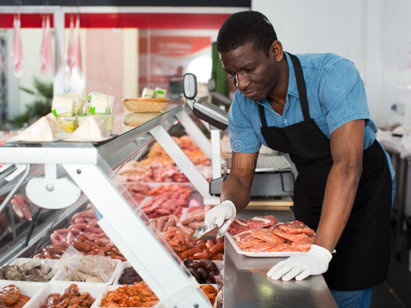 Butcher Working Behind Counter Stock Image - Image of offering ...
