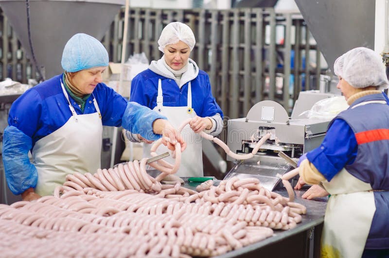 Butchers Processing Sausages at the Meat Factory. Stock Photo - Image ...