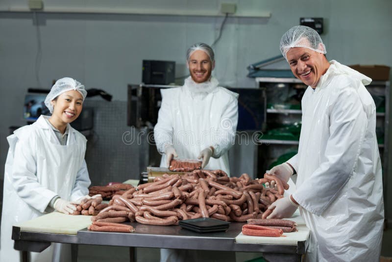 Butchers Processing Sausages Stock Photo - Image of coworker ...