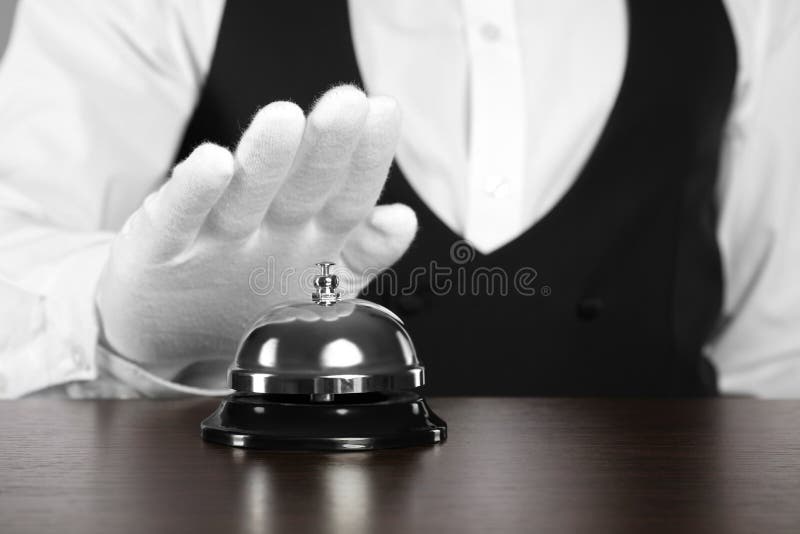 Butler Ringing Service Bell at Table, Closeup Stock Photo - Image of ...