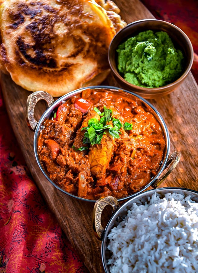 Butter Chicken with Rice and Naan Bread Served in Karahi Pots Stock ...