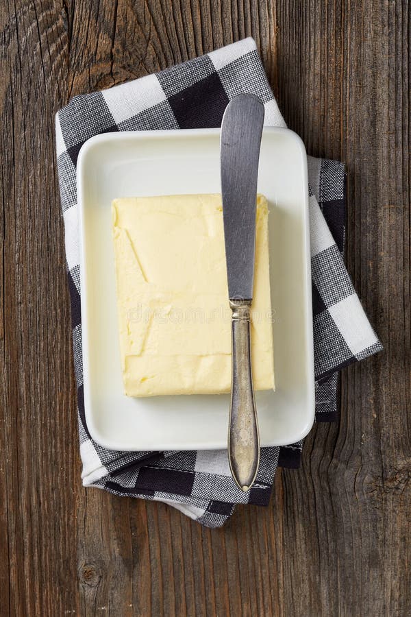 Butter Dish on Wooden Table, from Above Stock Photo - Image of food ...