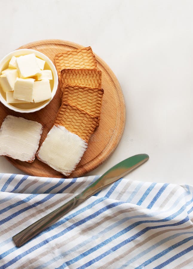 Butter Spread on Crispy Square Cookies on a Wooden Plate. Stock Image ...