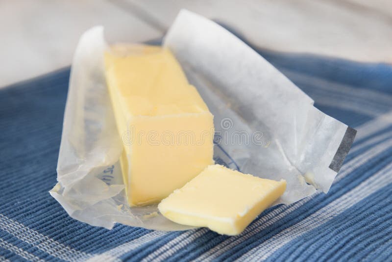 Stick of Butter in Paper Unwrapped Over White Stock Image - Image of ...