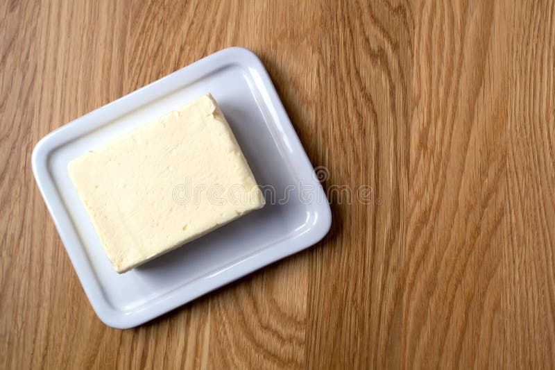 Butter on White Butter Dish on Wooden Table. Dairy Products. Top View ...