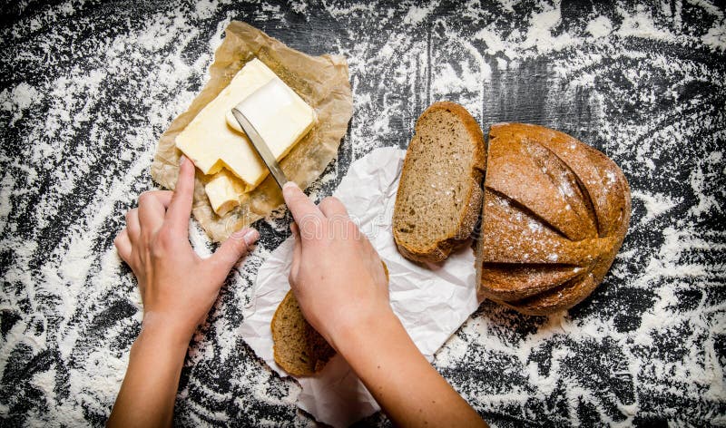 The Buttering of Bread with Butter on Board with Flour. Stock Photo ...