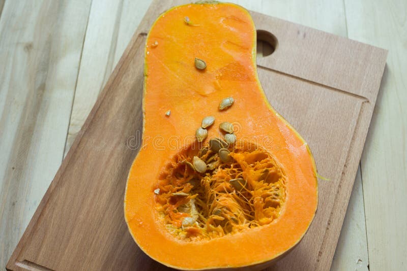 Butternut Squash Cut in Half on a Wooden Surface Stock Image - Image of ...