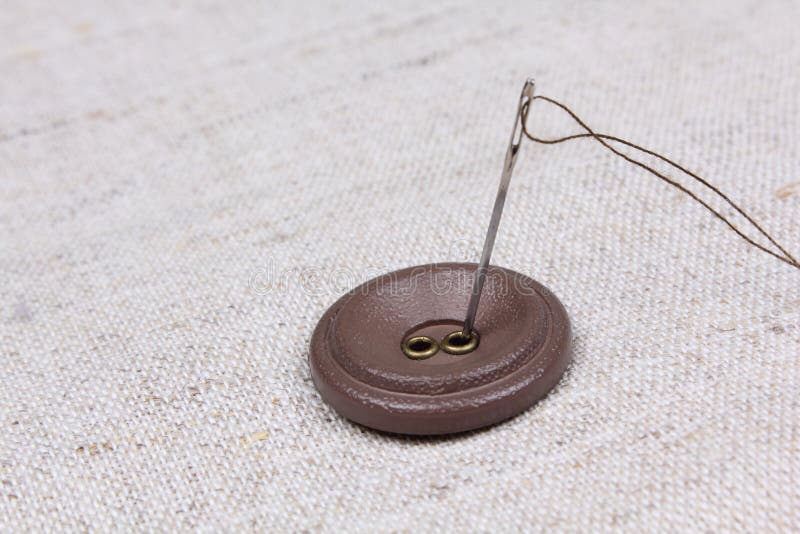 Button and Needle with a Thread Stock Photo - Image of metallic, fabric ...