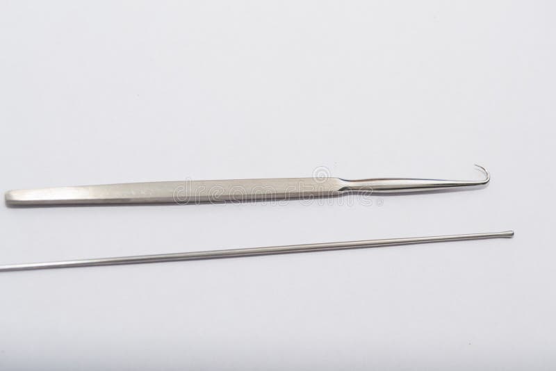 Buttoned Probe and Hook on Grey Surface Stock Photo - Image of steel ...