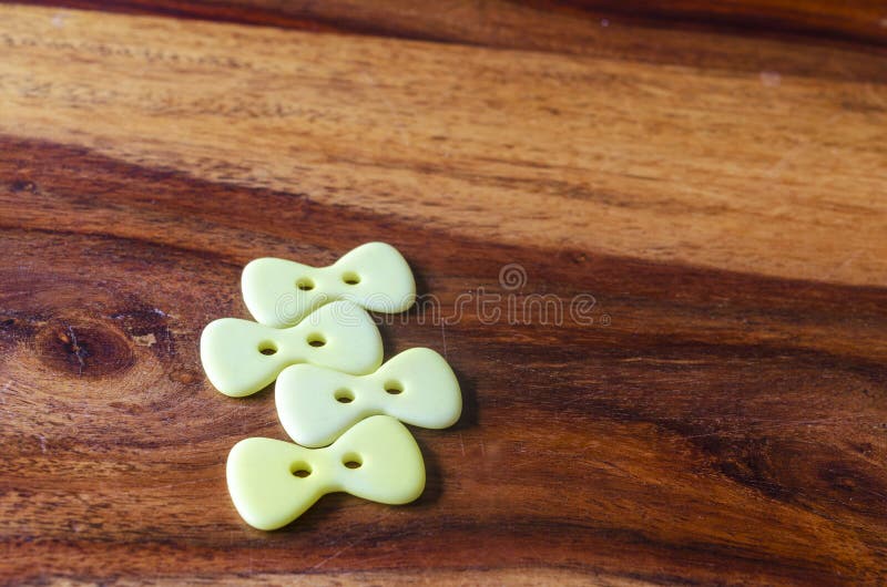 Buttons Shaped As Bows on a Wooden Background Stock Photo - Image of ...