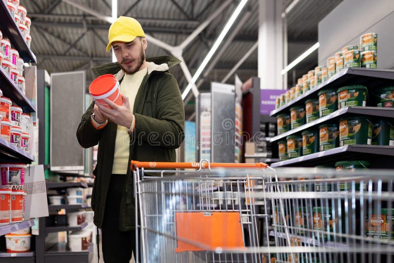 The Buyer Chooses Paint for Interior Work in the Store of Finishing ...