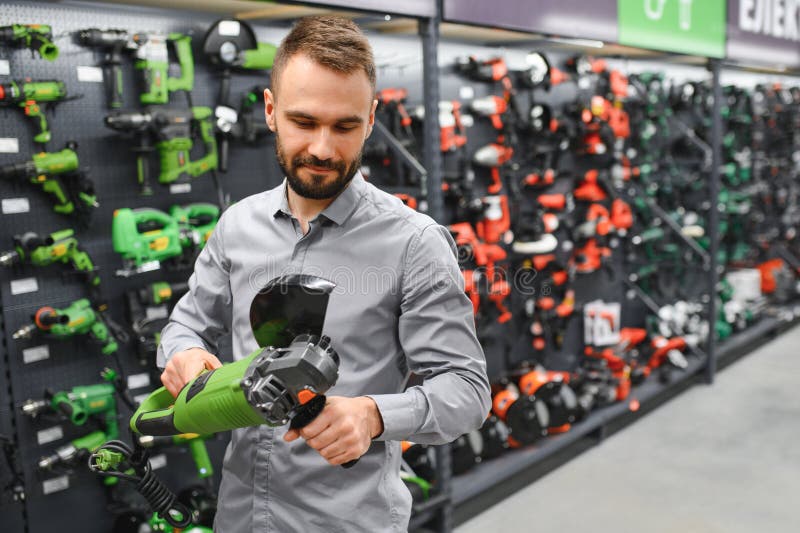 A Buyer in a Hardware Store Walks between with a Power Tool Stock Image ...