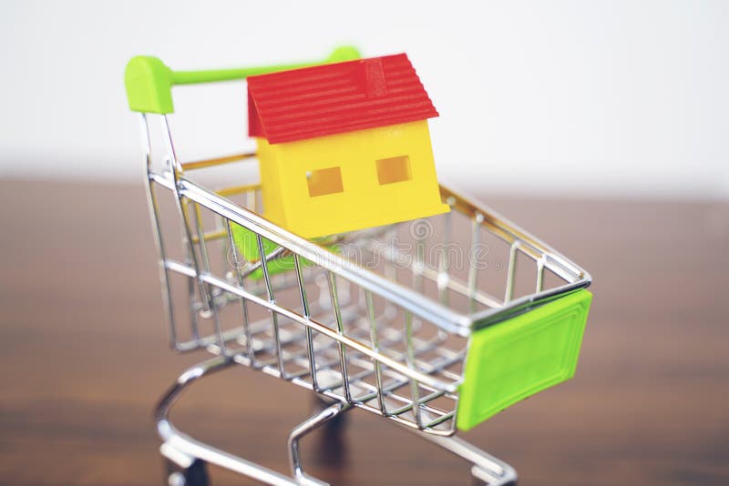 Buying a House Concept. Model Home in a Shopping Cart Stock Image ...