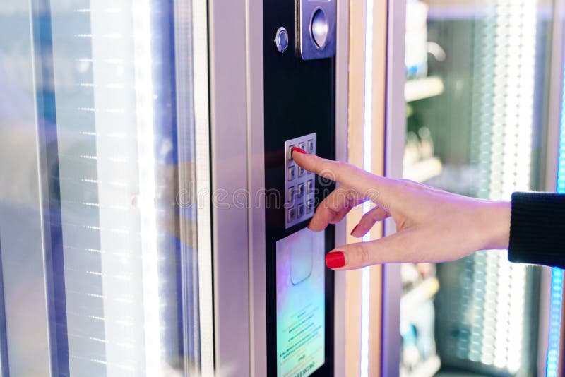A Woman S Hand Presses a Button, Selects a Product in the Vending ...