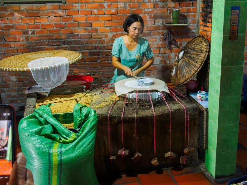 A Woman Spreads Rice Paper Material on a Heated Platter To Make Thin ...