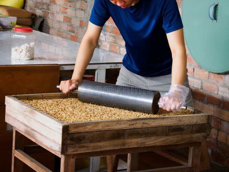 At a Candy Factory, a Worker Rolls Sweet Snack Material before Slicing ...