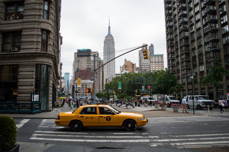 Cab and Empire State Building Under a Grey Sky in Manhattan, New York ...