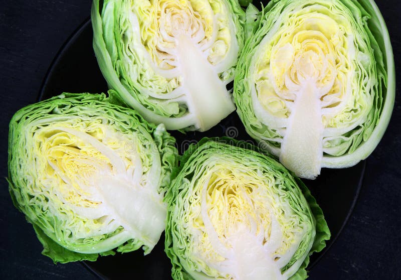 Cabbage Cut in Half on a Black Plate on a Black Background Stock Image ...