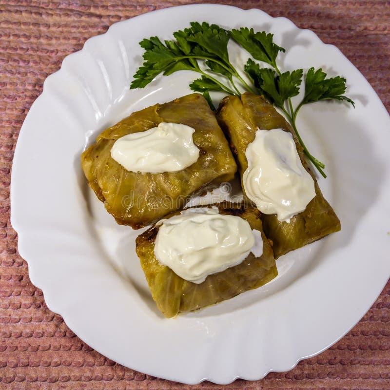 Cabbage Rolls with Rice, Wrapped in Cabbage Leaves and Under Sour Cream ...