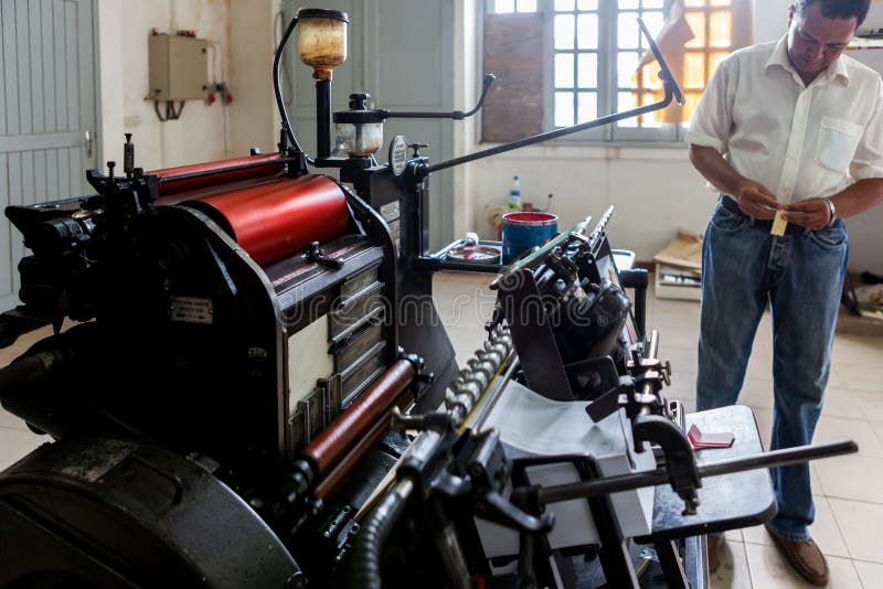CABINDA/ANGOLA - 08JUN2010 - Old Print Machine with Operator, on an Old ...