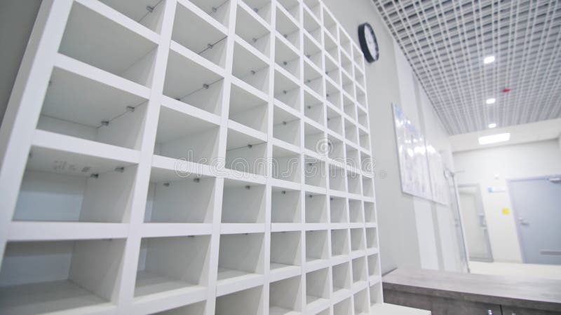 Cabinet with Cell Rack Behind Reception Counter in Hallway Stock Video ...