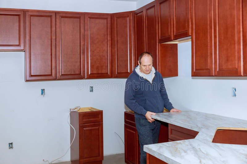 Cabinet Installation in a Kitchen Renovation Project Featuring a Man ...