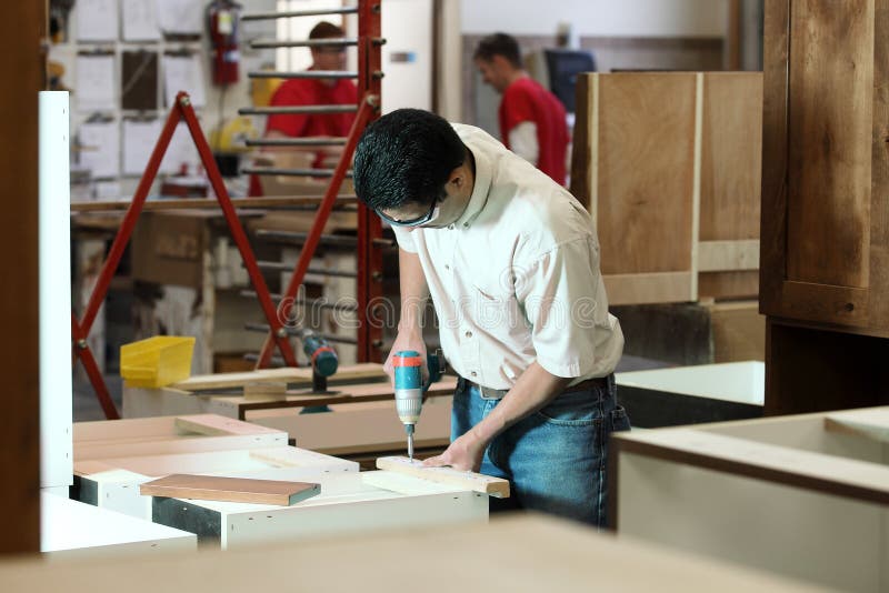 A Cabinet Maker Completing Final Assembly of a Cabinet Stock Image ...