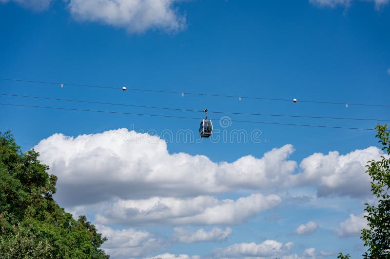 A Cable Car is Flying through the Sky Above a Forest Stock Image ...
