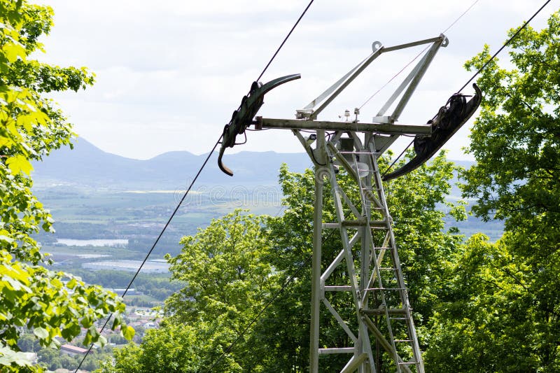 A Cable Car Support Tower Stands among Green Trees, Overlooking a ...