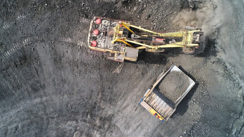 Cable Excavator Loads Overburden from the Body of a Mining Truck. Stock ...