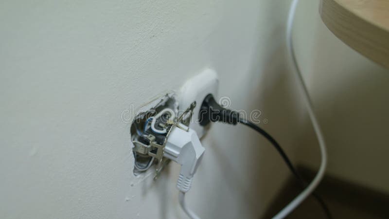 Broken Electrical Outlet in Beige Wall. White Electrical Outlet with ...