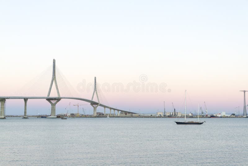 Cable-stayed Bridge and a Boat Near the Port during the Sunset Stock ...
