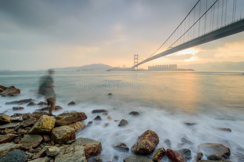 Cable-stayed Bridge during the Sunrise with a Blurred Moving Man Shot ...