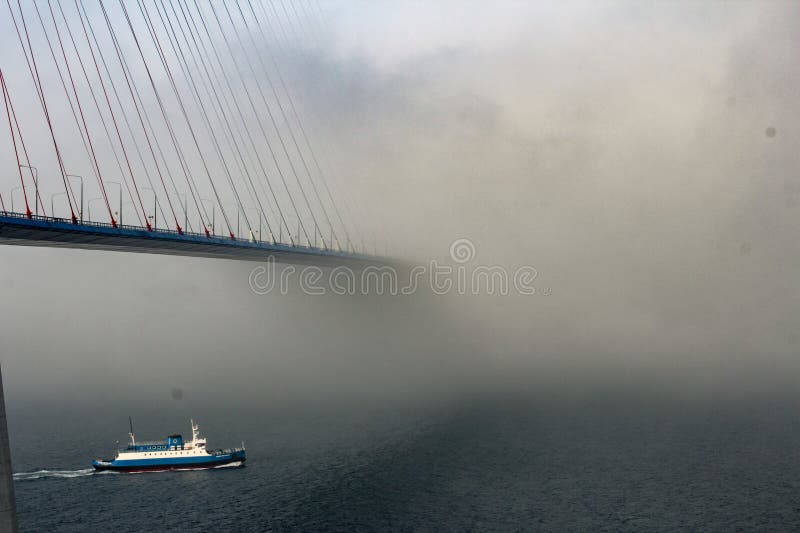 Cable-stayed Russky (russian) Bridge Partially Hidden by Fog and a Ship ...