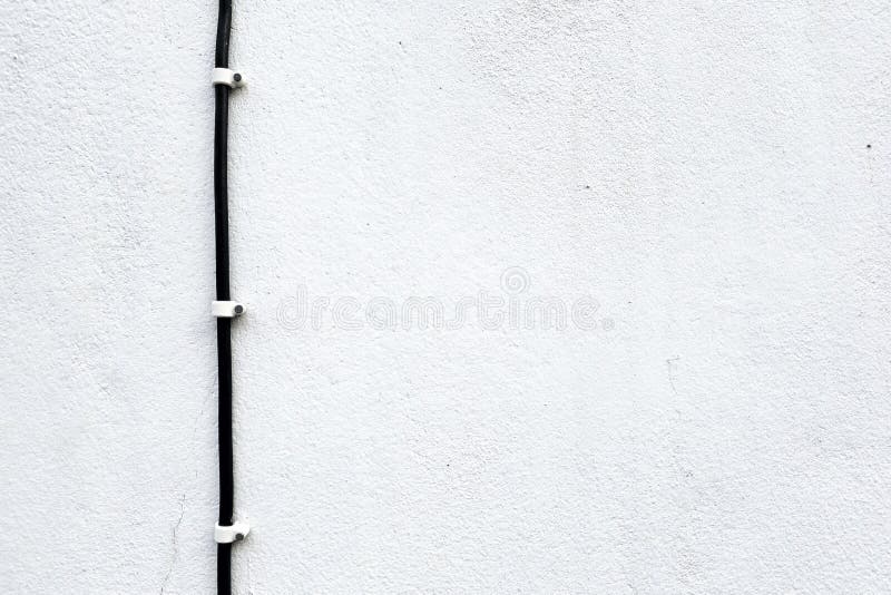 Cable with White Plastic Clips on Concrete Wall Background. Stock Photo ...