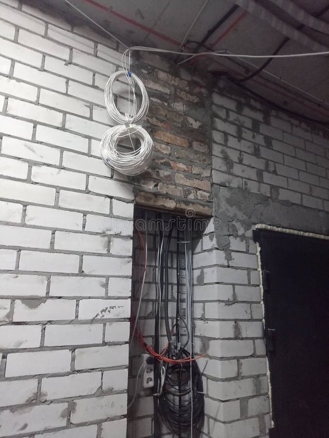 Cables on a brick wall stock image. Image of door, architecture - 358297799