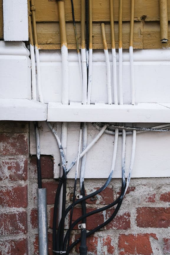 Cables on a building wall stock photo. Image of electricity - 344566318