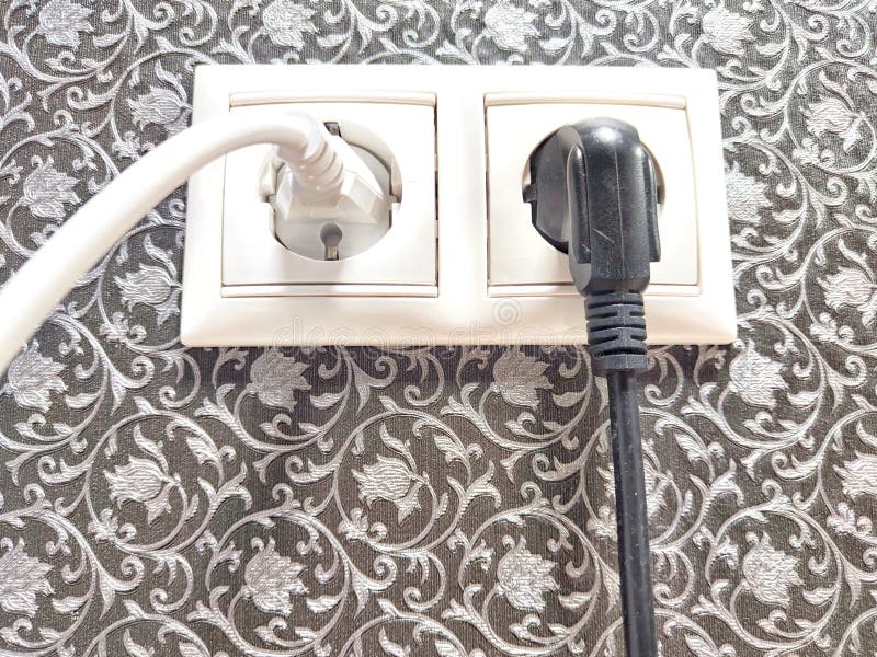 Cables Connected To Power Sockets Against a Decorative Wall. Dual ...